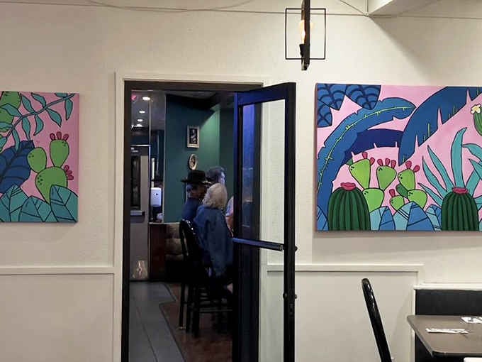 Vibrant cactus artwork pops against clean white walls. Local color, literally.