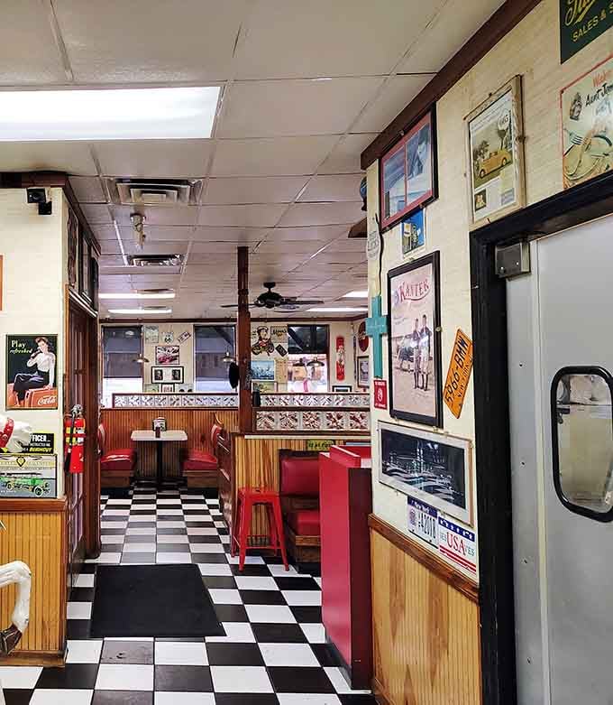 Vintage posters, license plates, and Route 66 signs covering every wall &mdash; this hallway tells a thousand stories.