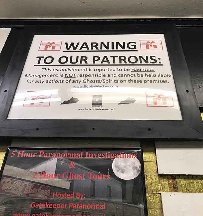 The warning sign doesn't mince words, basically saying "ghosts ahead, proceed at your own risk, no refunds."