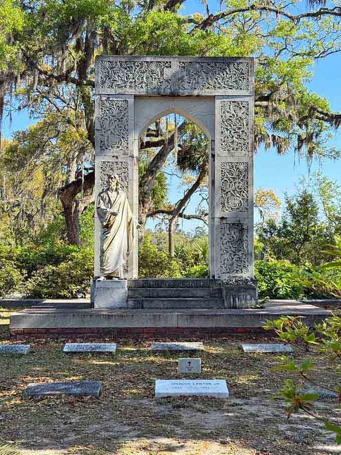 Intricate carved stonework and a robed figure make the Lawton plot feel like an outdoor cathedral nobody told you about.