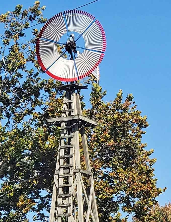 A classic windmill reaching above the treetops, red, white, and spinning. Indiana's version of a landmark moment, honestly.