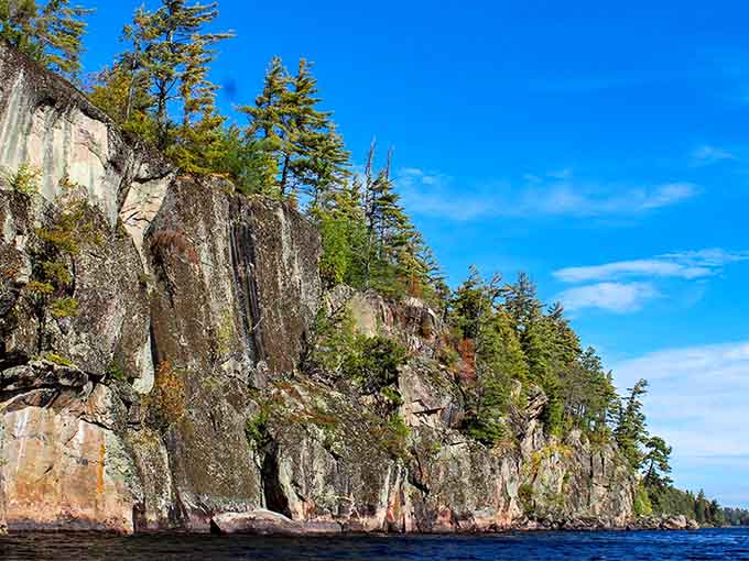Ancient granite cliffs rising straight out of the water, reminding you that Minnesota has been dramatic long before social media.