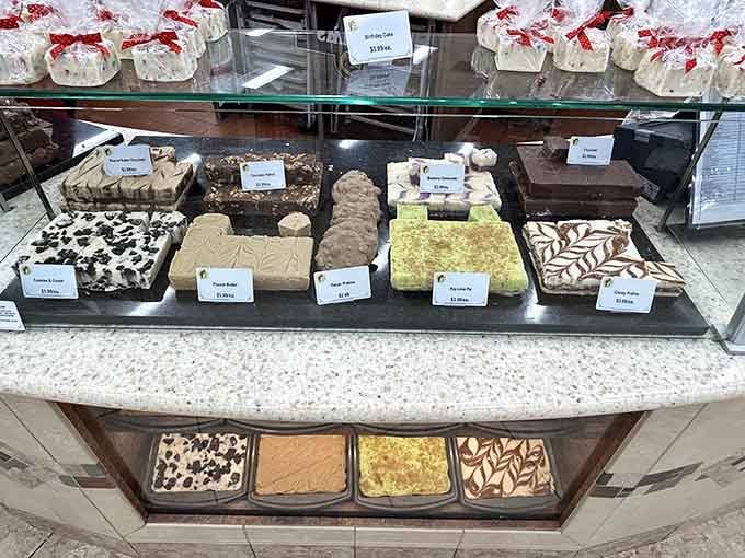Freshly made fudge in flavors like praline, peanut butter, and pistachio pie, displayed like edible works of art.