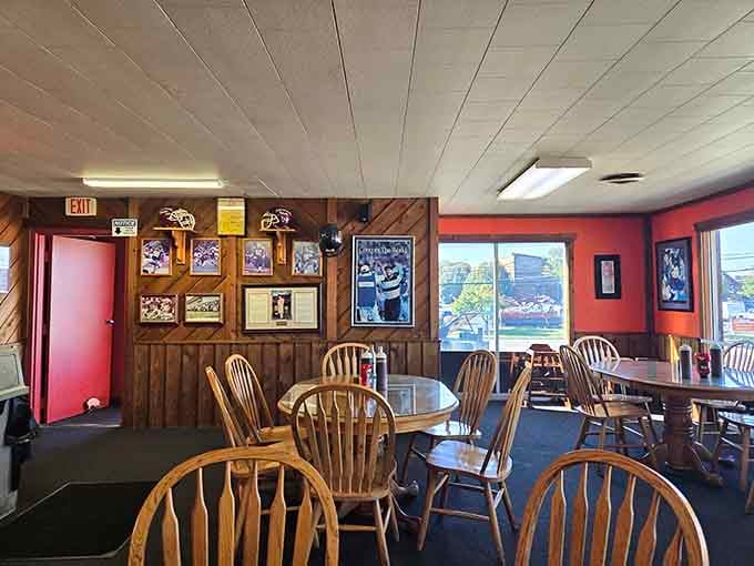 Wood-paneled walls, framed sports photos, and afternoon light streaming through the windows, this corner of the dining room feels genuinely welcoming.