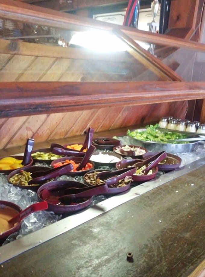A fresh, well-stocked salad bar sitting cool and ready. Because balance matters, even in pizza paradise.
