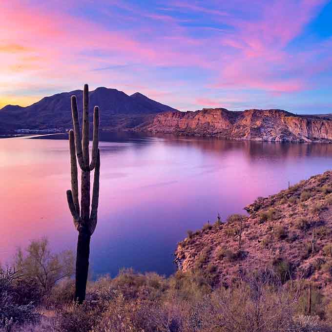 Sunset transforms the lake into liquid cotton candy, proving nature has zero chill with color palettes.