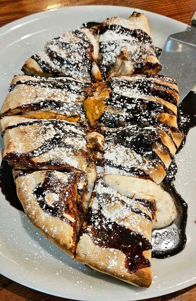 Dessert calzone dusted with powdered sugar and drizzled with chocolate, because regular dessert seemed too easy.