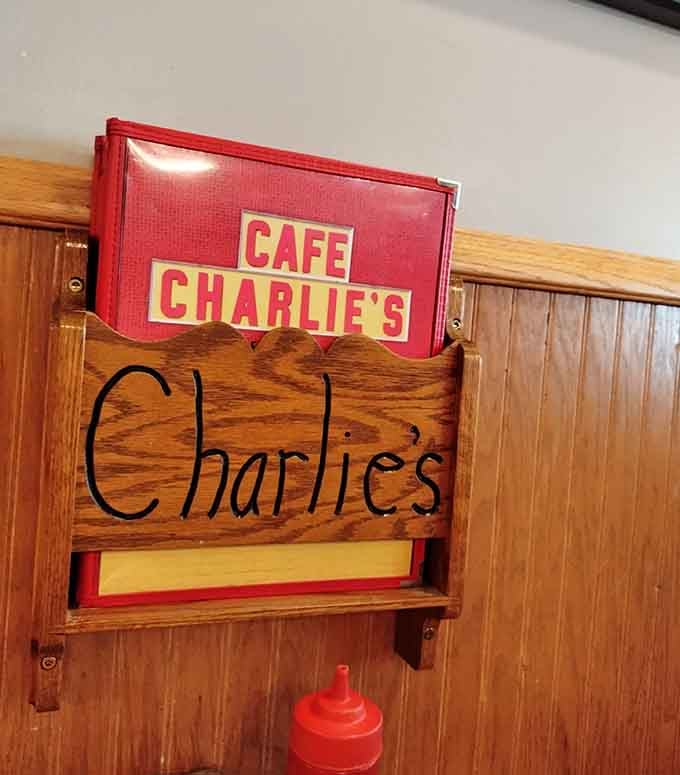 Red menus tucked neatly into a handcrafted wooden holder. Even the small details here feel intentional and warm.
