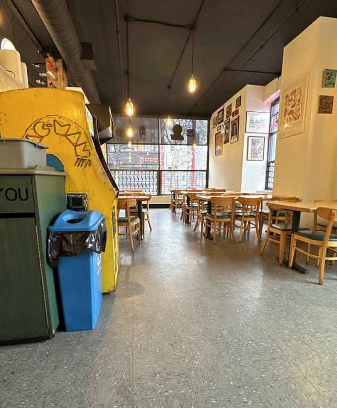 A vintage Pac-Man cabinet next to your lunch table is the kind of detail that makes you smile instantly.