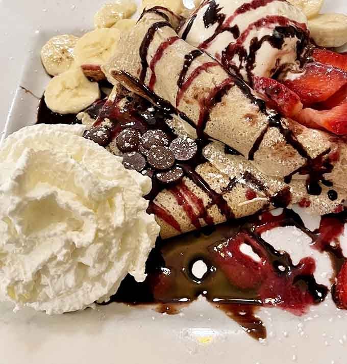 Strawberries, bananas, chocolate chips, chocolate sauce, ice cream, and whipped cream &mdash; this cr&ecirc;pe is the dessert that other desserts aspire to be.