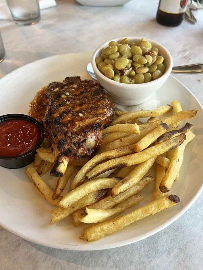 Pork chop with butter beans and crispy fries delivers the kind of plate that makes everything okay.