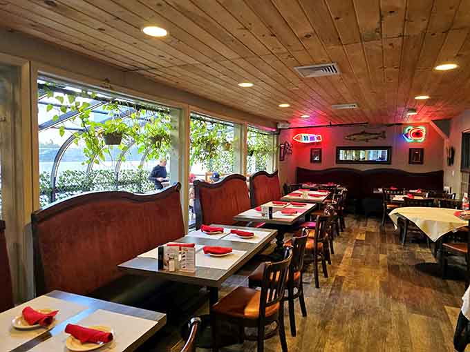 Water views, wood ceilings, and warm lighting. This dining room earns its relaxed, unhurried atmosphere completely.