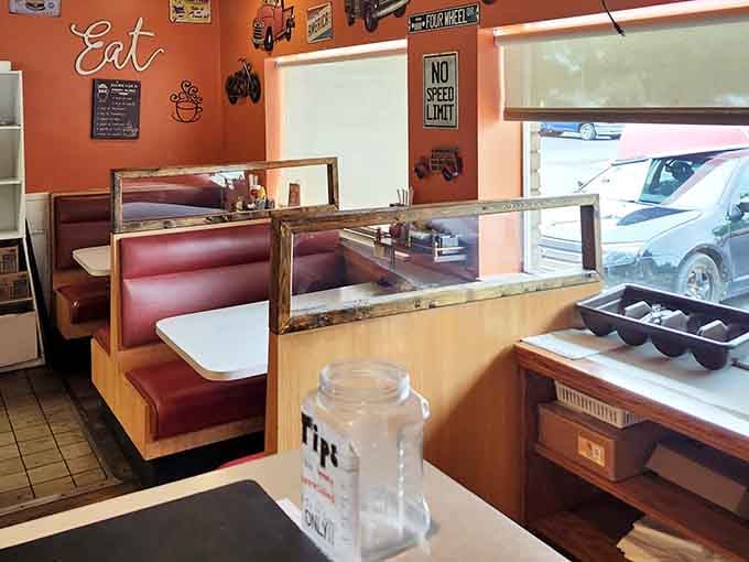 The warm orange walls adorned with nostalgic road signs create a retro vibe that feels both familiar and wonderfully timeless.