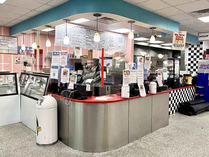 A curved counter with checkered trim and a full menu overhead. This is where great decisions get made daily.