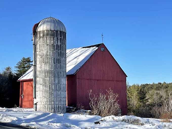 A red barn and a silver silo standing tall against a brilliant blue winter sky, honestly, frame this one.