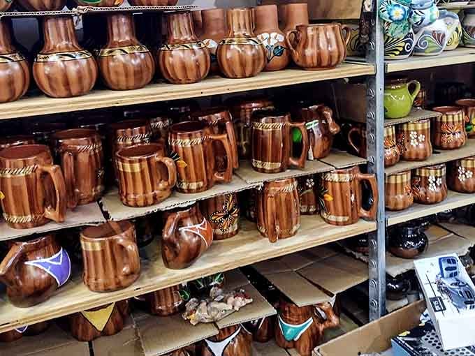 Hand-painted ceramic mugs and pitchers stacked high, each one a little work of art you can actually drink from.