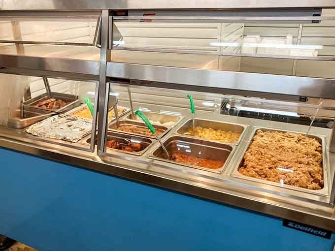 That hot food display case holds mac and cheese, red hash, and enough comfort to fix a bad week.