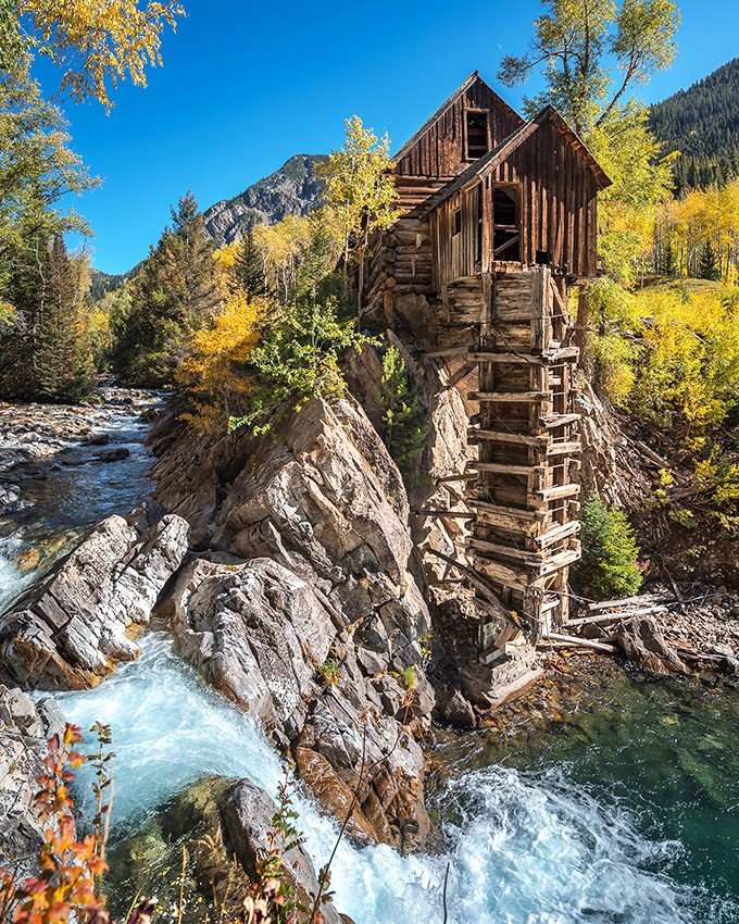 The mill clings to its rocky perch, defying gravity and common sense with equal determination and style.