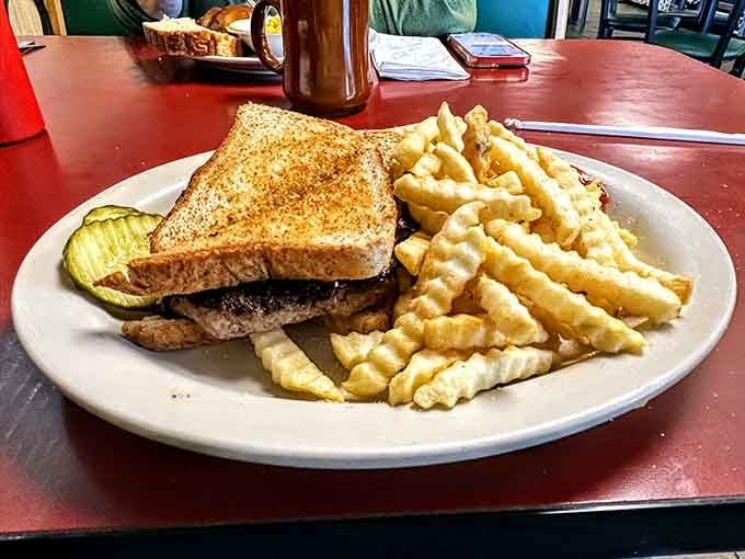 A patty melt on toasted bread with crinkle fries alongside. Lunch just found its Wisconsin headquarters.