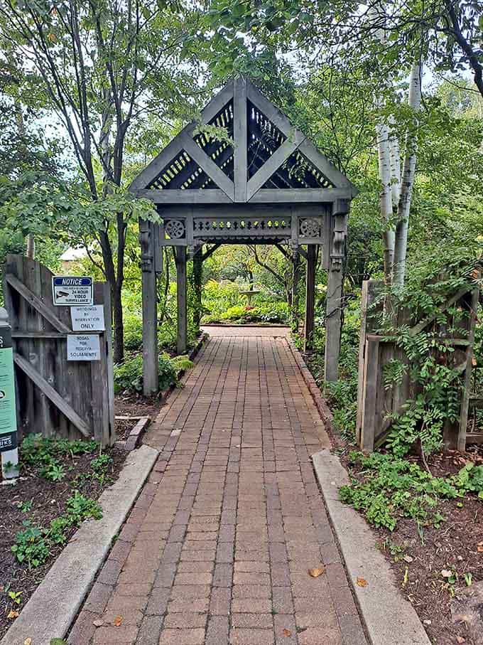 Walking through this carved wooden pergola entrance feels like crossing into a completely different world.