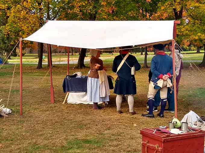 Under the tent, costumed interpreters chat like neighbors at a block party, just with considerably more wool.