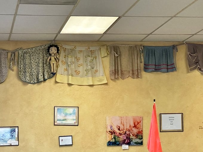 Aprons, portraits, and local art sharing the same wall. Dot's doesn't follow a decorating rulebook.