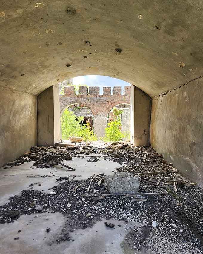 That arched tunnel vault framing a view of crumbling brick arches beyond is pure cinematic gold.