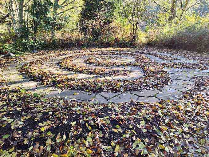 Autumn leaves have settled into every groove of this stone spiral labyrinth, turning an already magical path into something that belongs in a storybook.