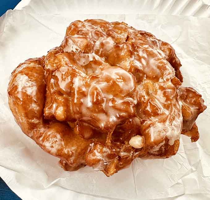Apple fritters this size require both hands and zero shame, delivering cinnamon-sugar bliss with every ridiculous bite.
