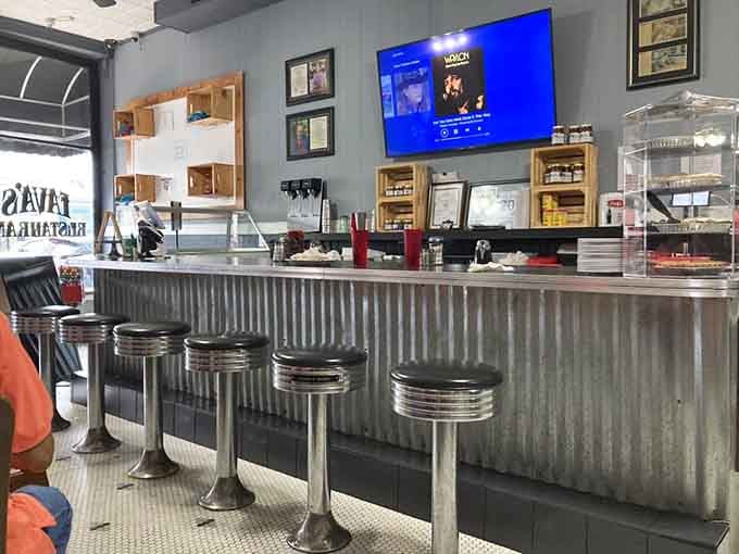 Chrome stools, a corrugated metal counter, and country music on the screen. This is what a proper diner counter looks like.