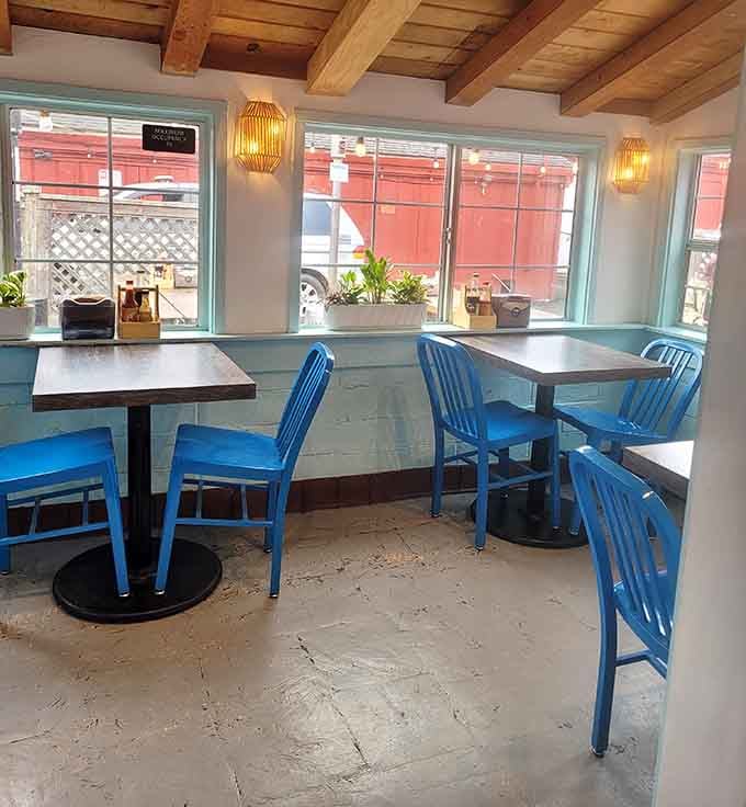 Bright blue chairs, exposed wood beam ceilings, and warm wall sconces. Casual never looked this cheerful or this inviting.