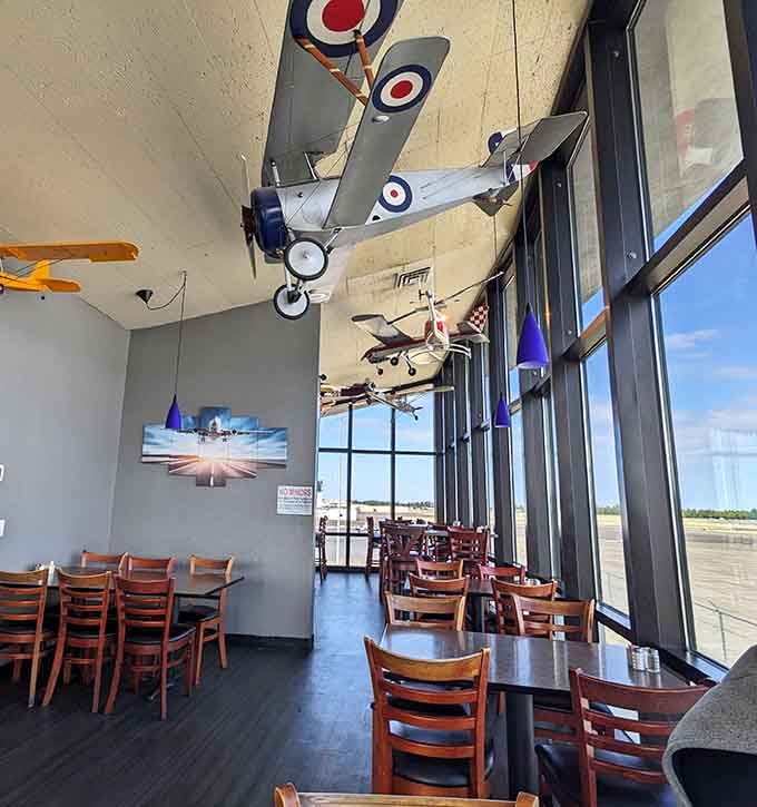Floor-to-ceiling windows frame the runway like a widescreen movie, with real pilots providing all the entertainment you need.