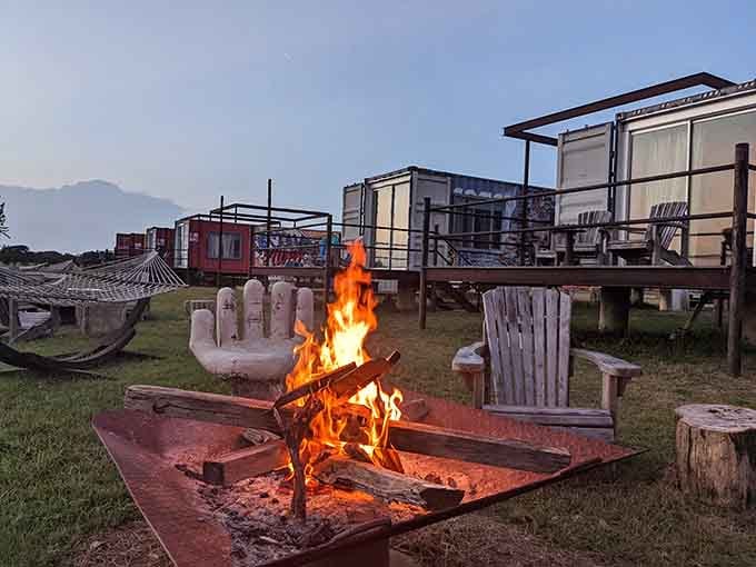 Fire crackling, stars overhead, and a giant concrete hand sculpture keeping watch nearby. FlopHouze evenings are wonderfully, gloriously weird.