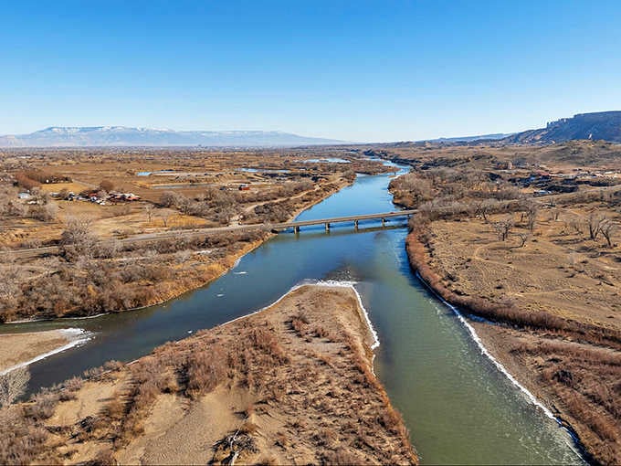The Colorado River moves through the Grand Valley with quiet authority, indifferent to how beautiful it all looks.