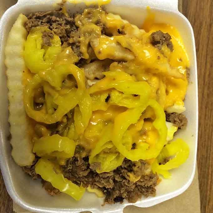 Philly steak fries loaded with meat and cheese transform a simple side into a meal that requires strategic napkin placement.