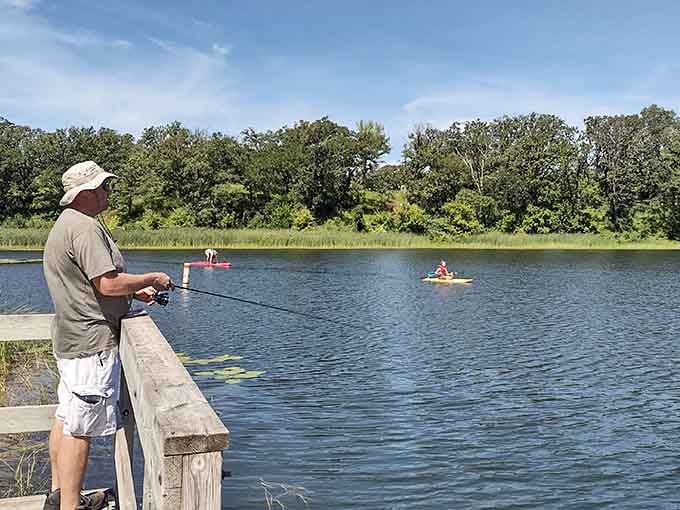 Fishing from the dock while kayakers glide past creates the kind of summer scene Norman Rockwell would paint.