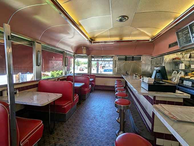 Red vinyl booths, marble tabletops, and warm light pouring through the windows, this is exactly where good conversations happen.