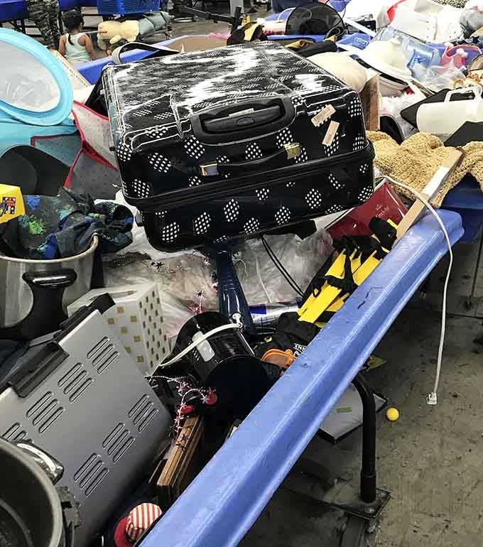 A hard-shell suitcase sits proudly on top of the pile, ready for its next adventure with a new owner.