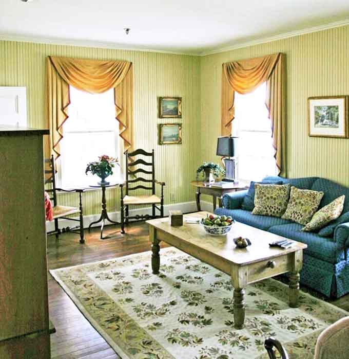 Blue sofas, warm drapes, and afternoon light pouring in. This living room is the definition of "I could get used to this."