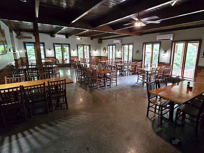 Spacious dining room with plenty of natural light streaming through windows that overlook the surrounding Kentucky River landscape.