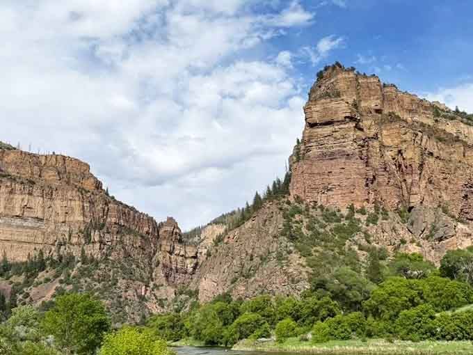 Glenwood Canyon's towering walls rise like ancient sentinels, making you feel wonderfully small in the best way.