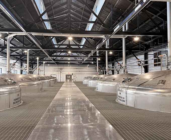 Rows of massive fermentation tanks stretching into the distance. This is where the magic quietly, bubblingly begins.