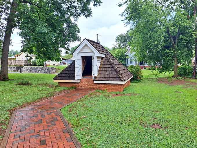 This little pyramid-roofed cellar on the Ivy Green grounds proves even the outbuildings have personality here.