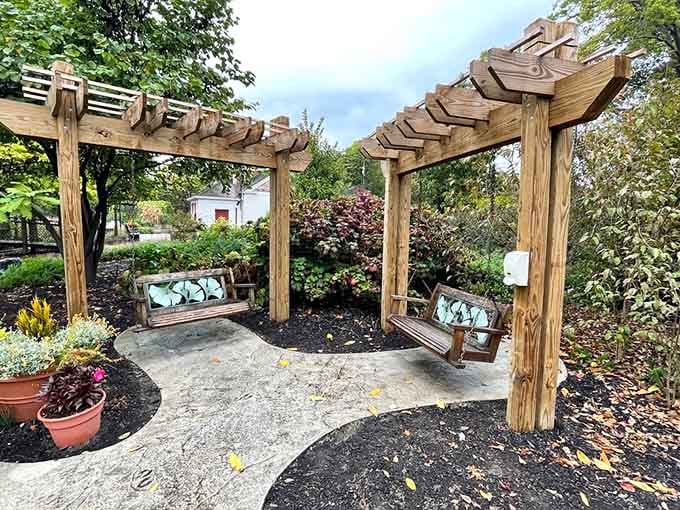 Pergola swings surrounded by garden color, this is what a proper afternoon off actually looks like.