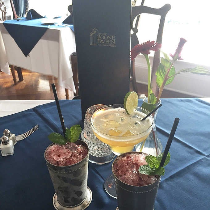 Mint juleps in silver cups, a citrus cocktail in crystal, and suddenly Kentucky feels like the best idea you've ever had.