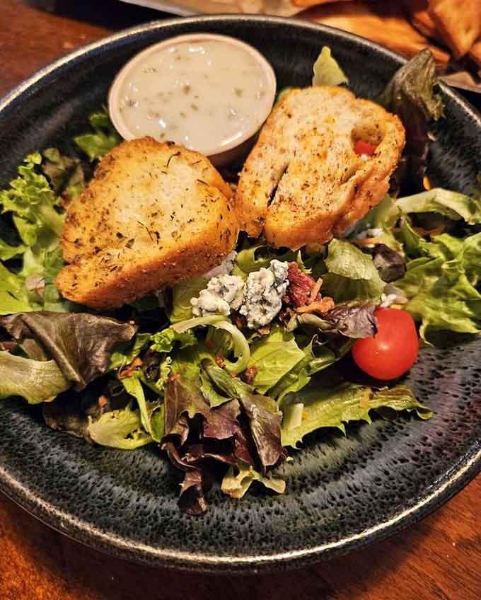 Mixed greens, blue cheese crumbles, cherry tomatoes, and thick garlic toast. A salad that actually makes you excited to eat salad.