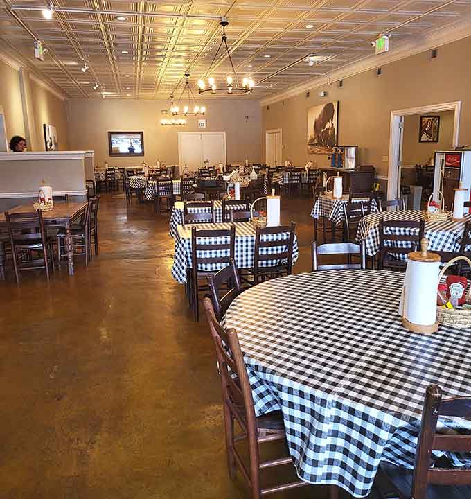 Warm pendant lighting, tin ceiling tiles, and checkered tables stretching across the room, this dining room earns every bit of its reputation.
