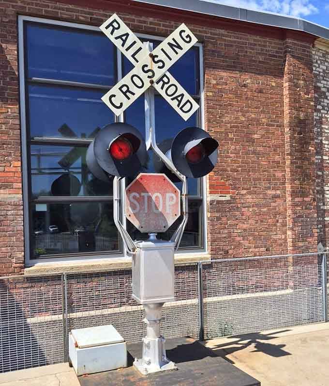 A vintage railroad crossing signal standing guard outside, because some things never go out of style.