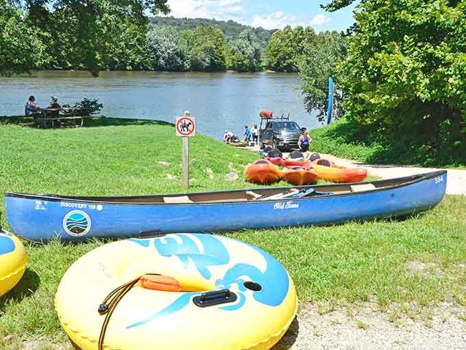Canoes, kayaks, and tubes lined up riverside, all of them quietly asking the same question: which one's yours?