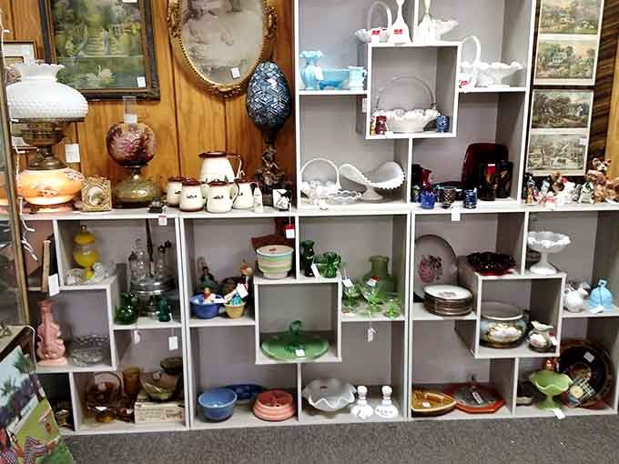 Milk glass and colored pottery create a rainbow of vintage kitchen charm on every single shelf here.